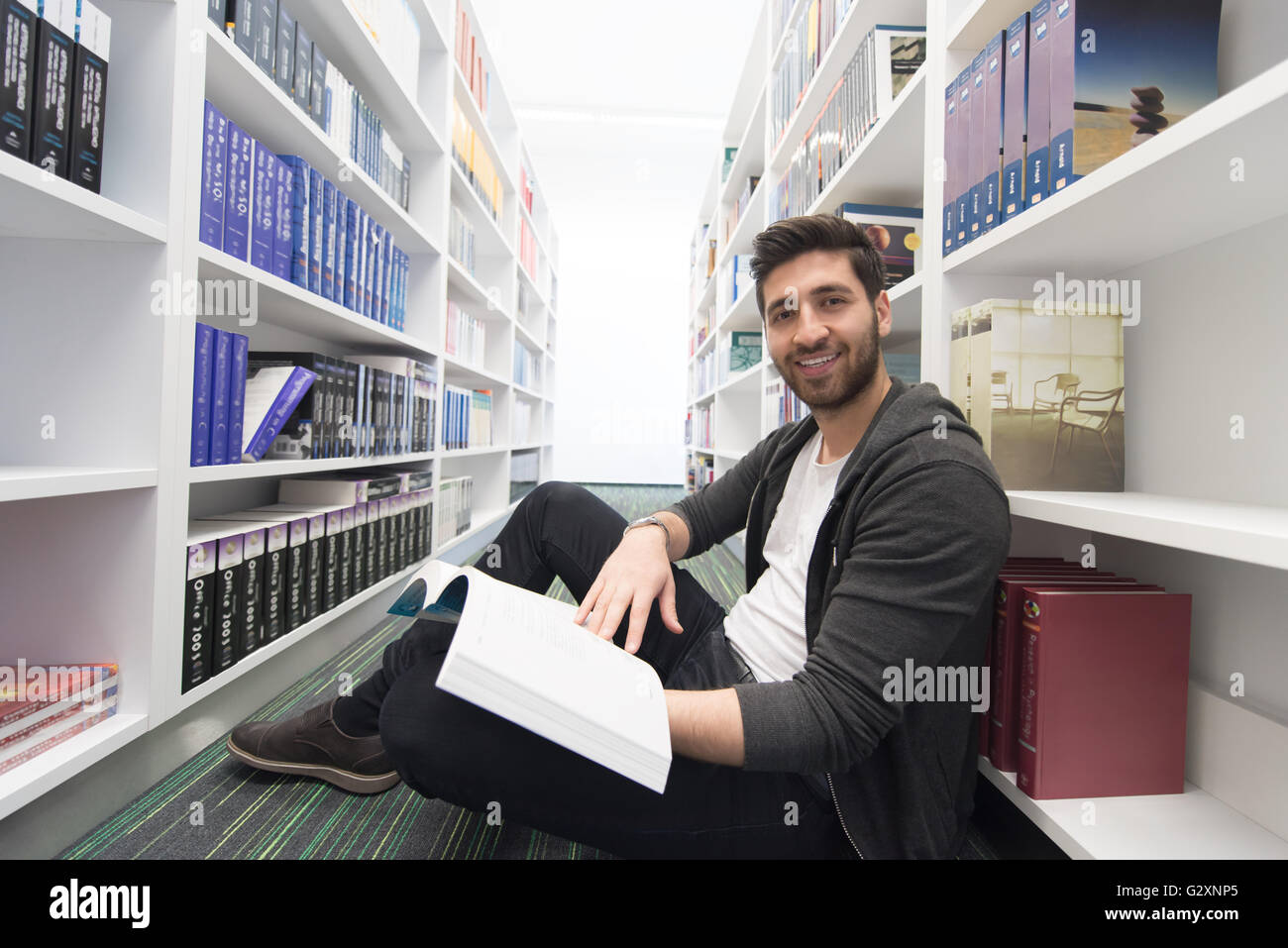 Student reading book in school library. Study lessons for exam. Hard ...