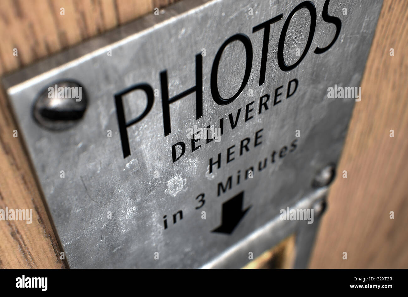 A 3D render of an illuminated vintage photo booths retrieval slot with ...
