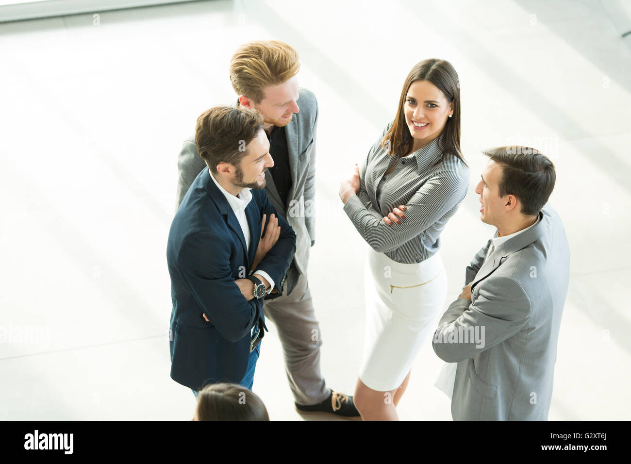 Young people standing in the modern office Stock Photo - Alamy