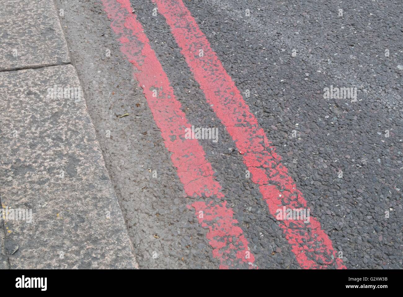 Double red lines on a red route in London Stock Photo - Alamy