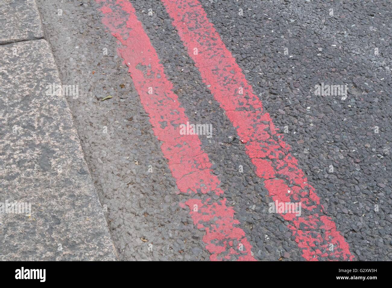 Double red lines on a red route in London Stock Photo - Alamy