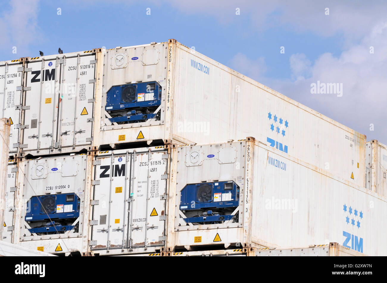 A stack of white shipping containers on blue sky background Stock Photo ...