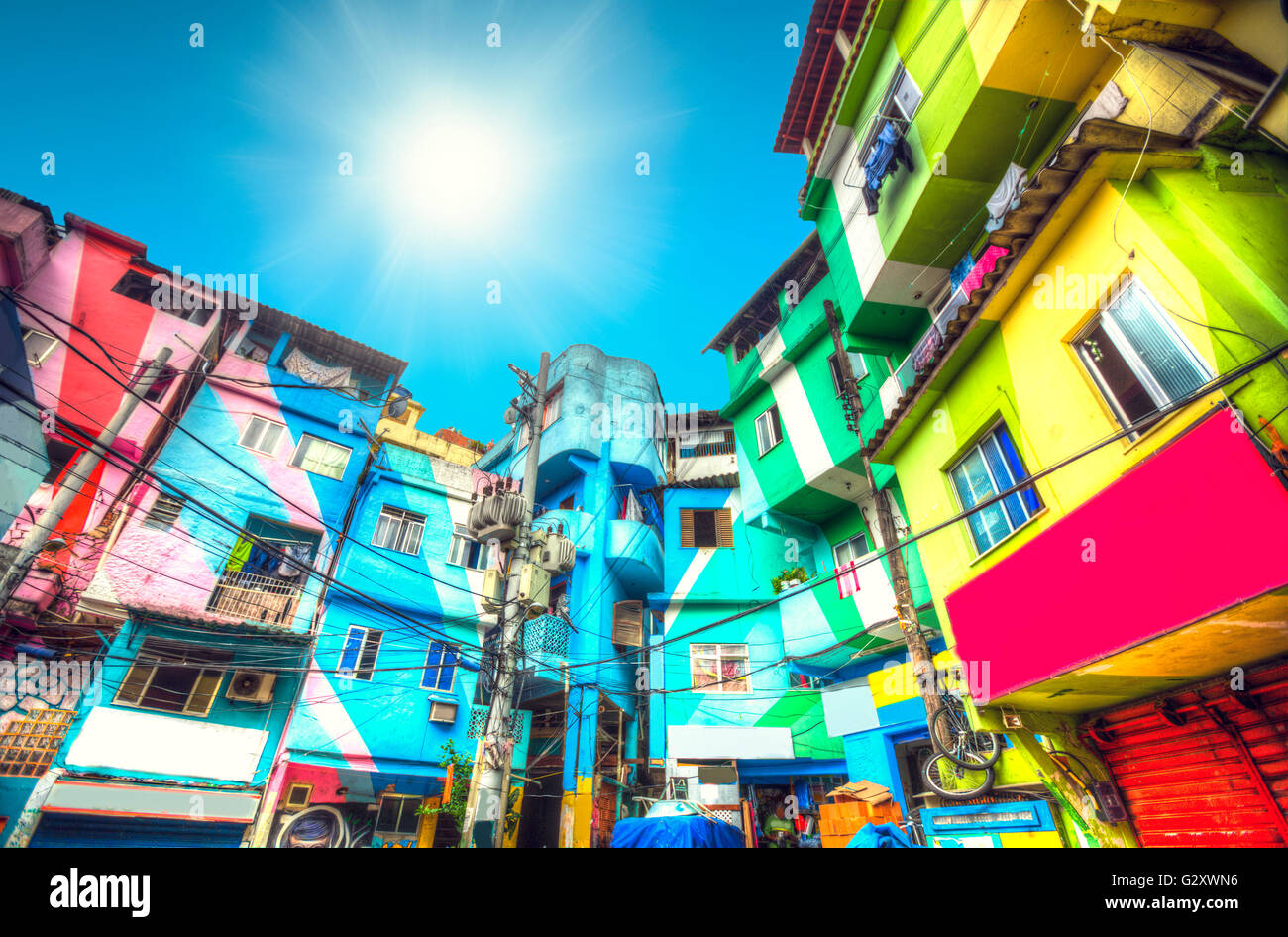 the sun is shining. Colorful painted buildings of Favela in Rio de ...