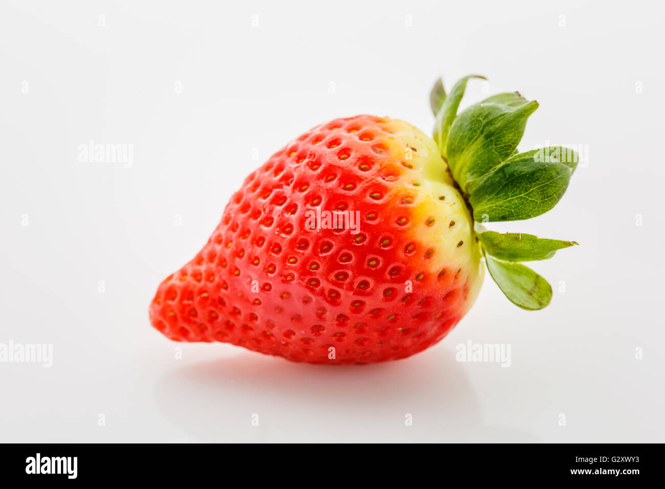 Closeup of not fully ripe strawberry Stock Photo - Alamy