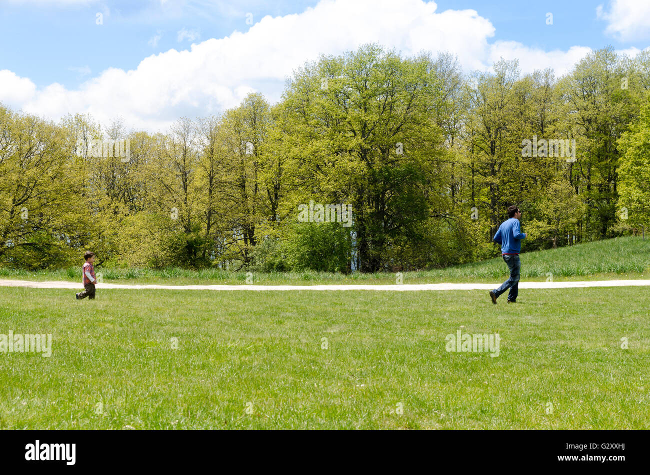 Father and son play on the field Stock Photo - Alamy