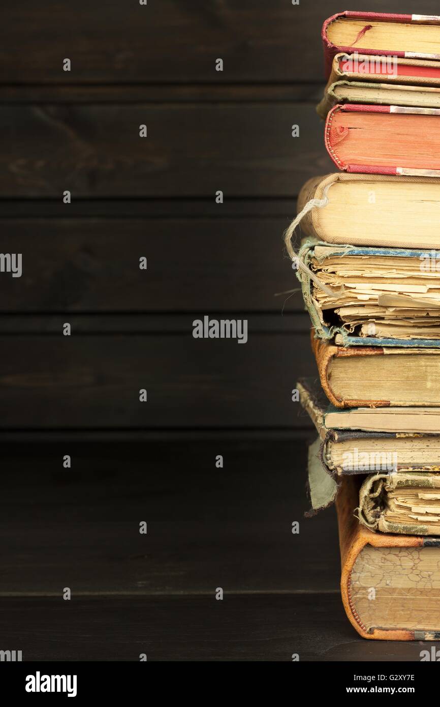 Front view of old books stacked on a shelf. Books without title and ...