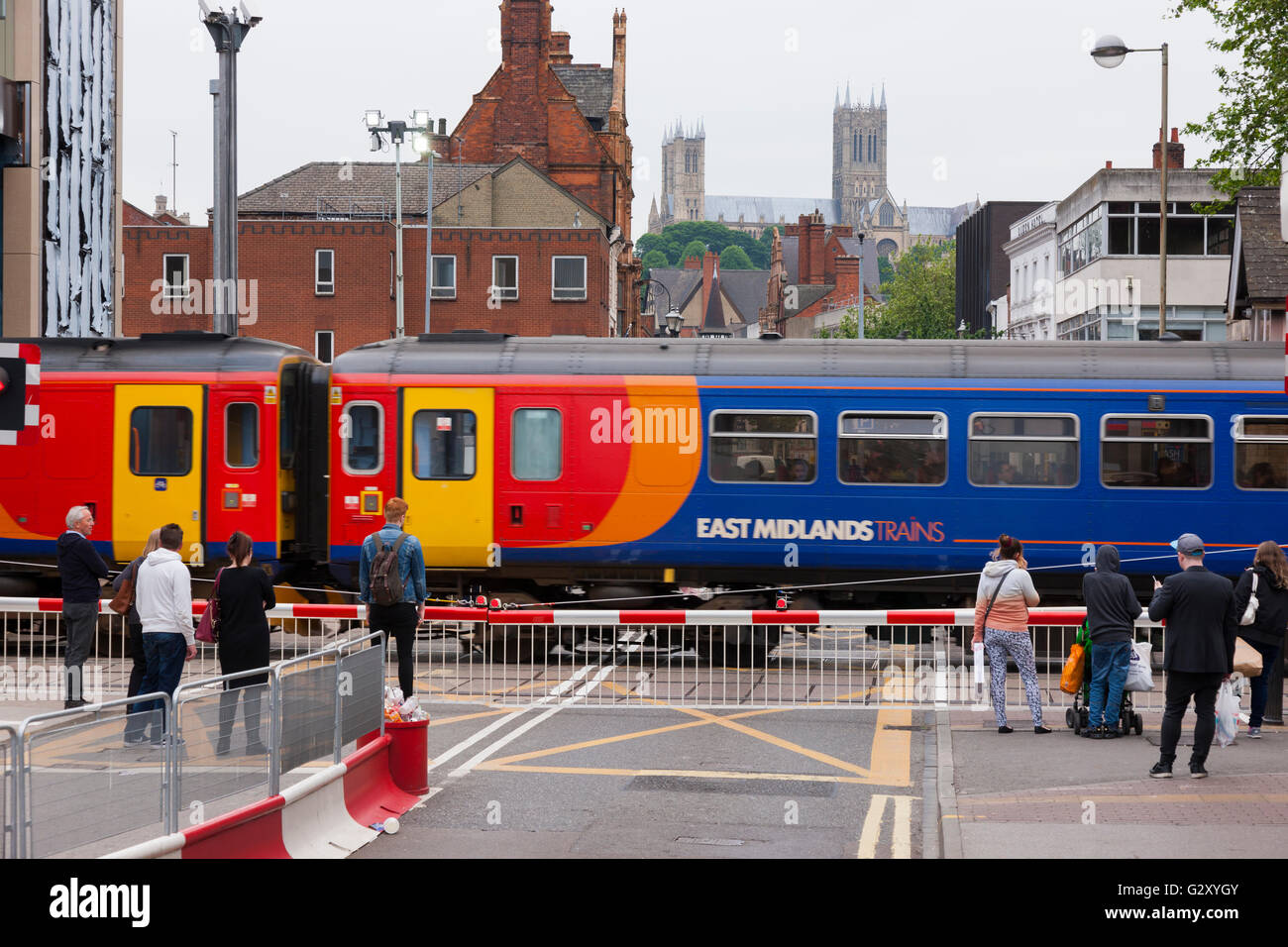 People / pedestrians / person wait / waits / waiting at a railway level ...