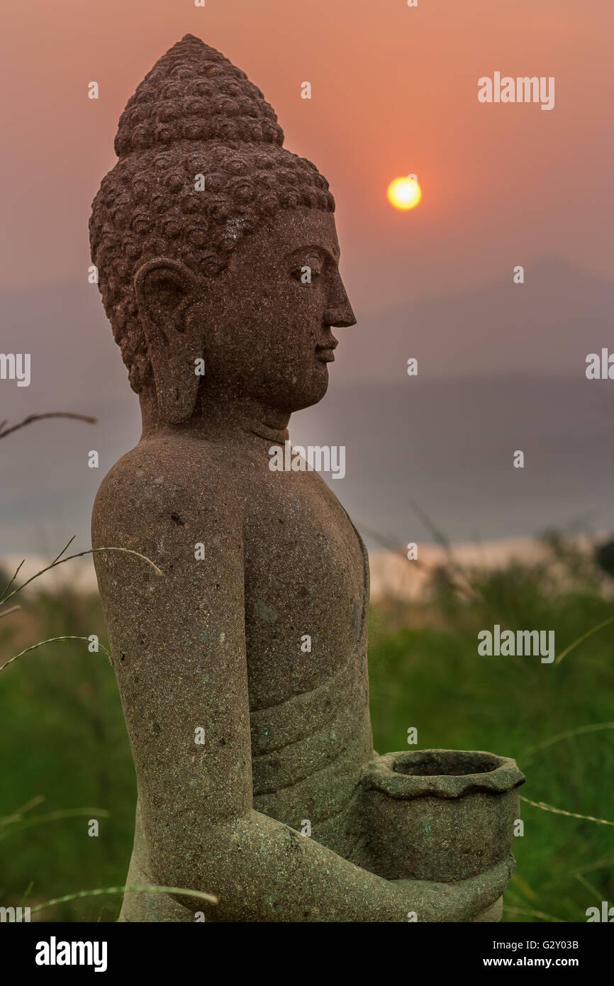Buddha with Sun in the background Stock Photo - Alamy