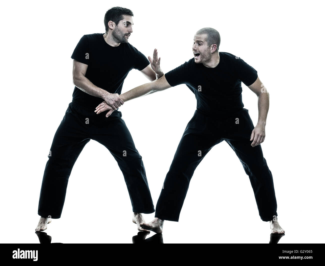 two caucasian men krav maga fighters fighting isolated silhouette on ...