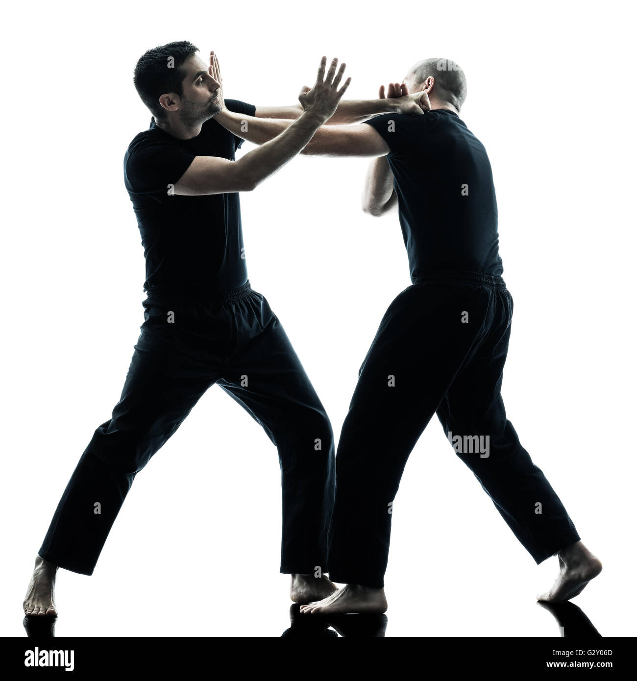 two caucasian men krav maga fighters fighting isolated silhouette on ...