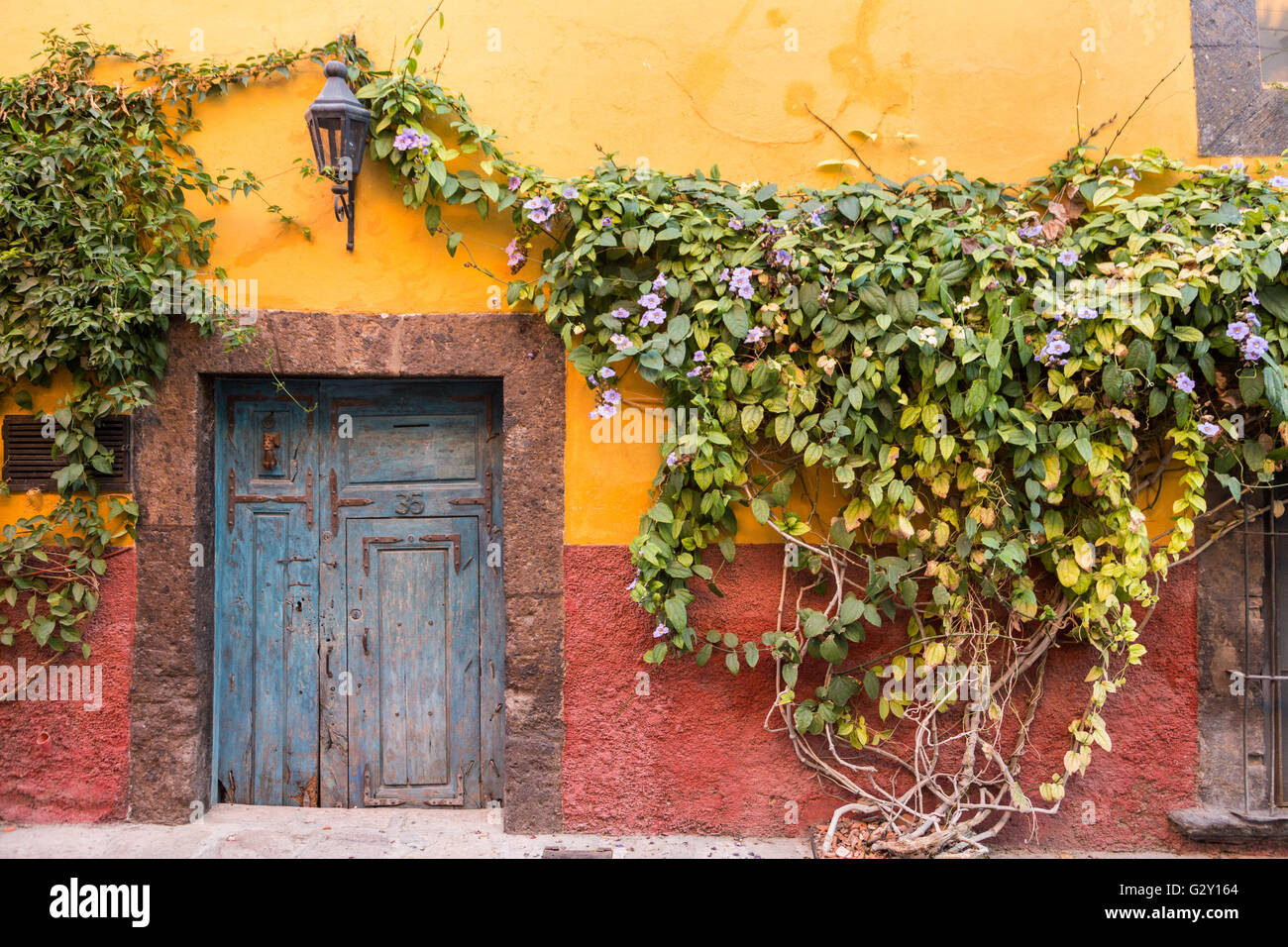 A traditional hacienda style painted wooden door on a historic home in ...
