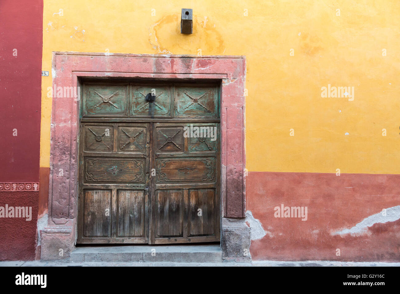 A traditional hacienda style painted wooden door on a historic home in ...
