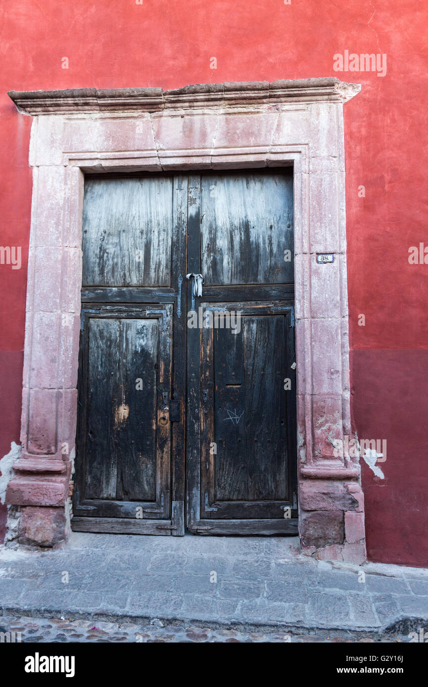 A traditional hacienda style painted wooden door on a historic home in ...