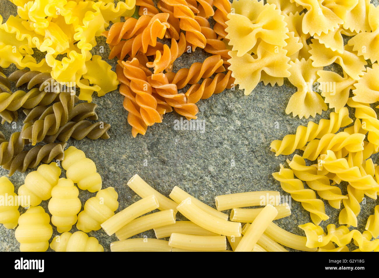 Pasta mix arranged on a stone table Stock Photo - Alamy