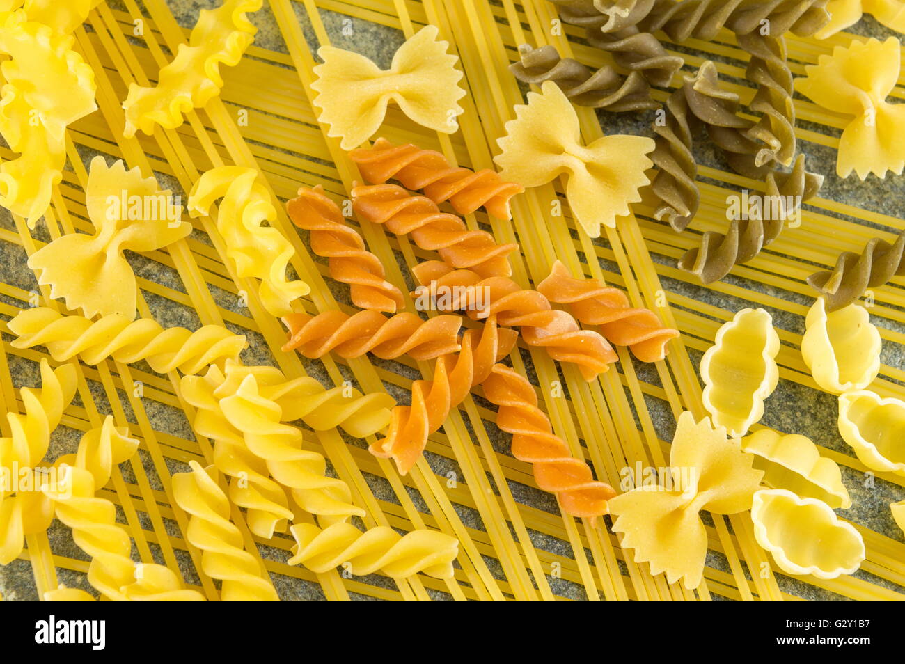 Pasta mix arranged on a stone table Stock Photo - Alamy