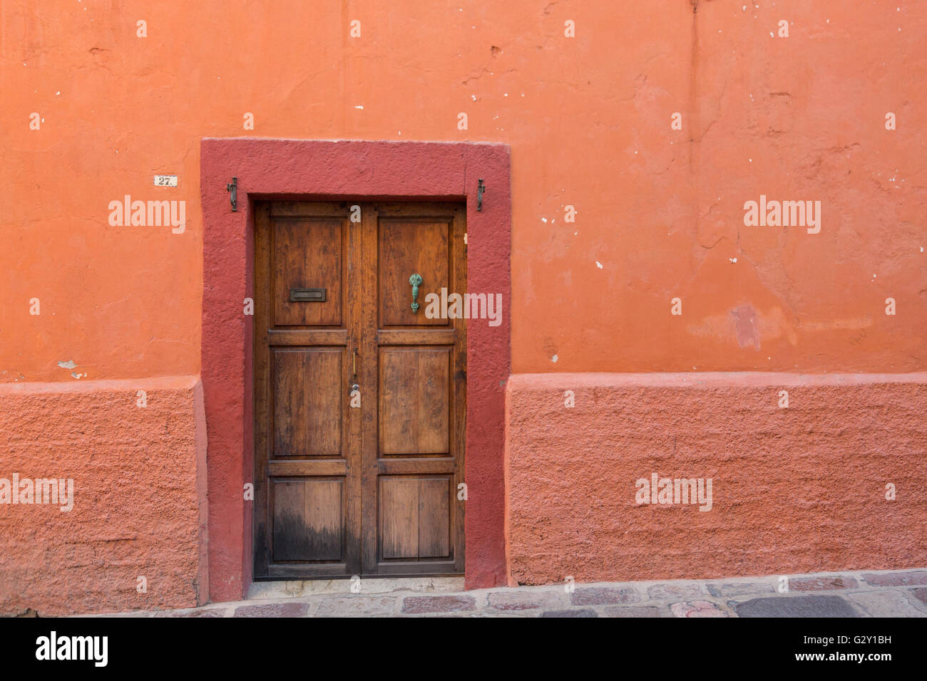 A traditional hacienda style painted wooden door on a historic home in ...