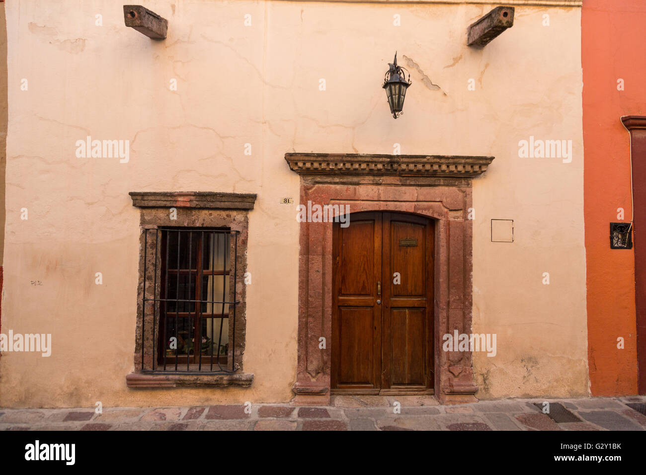 A traditional hacienda style painted wooden door on a historic home in ...