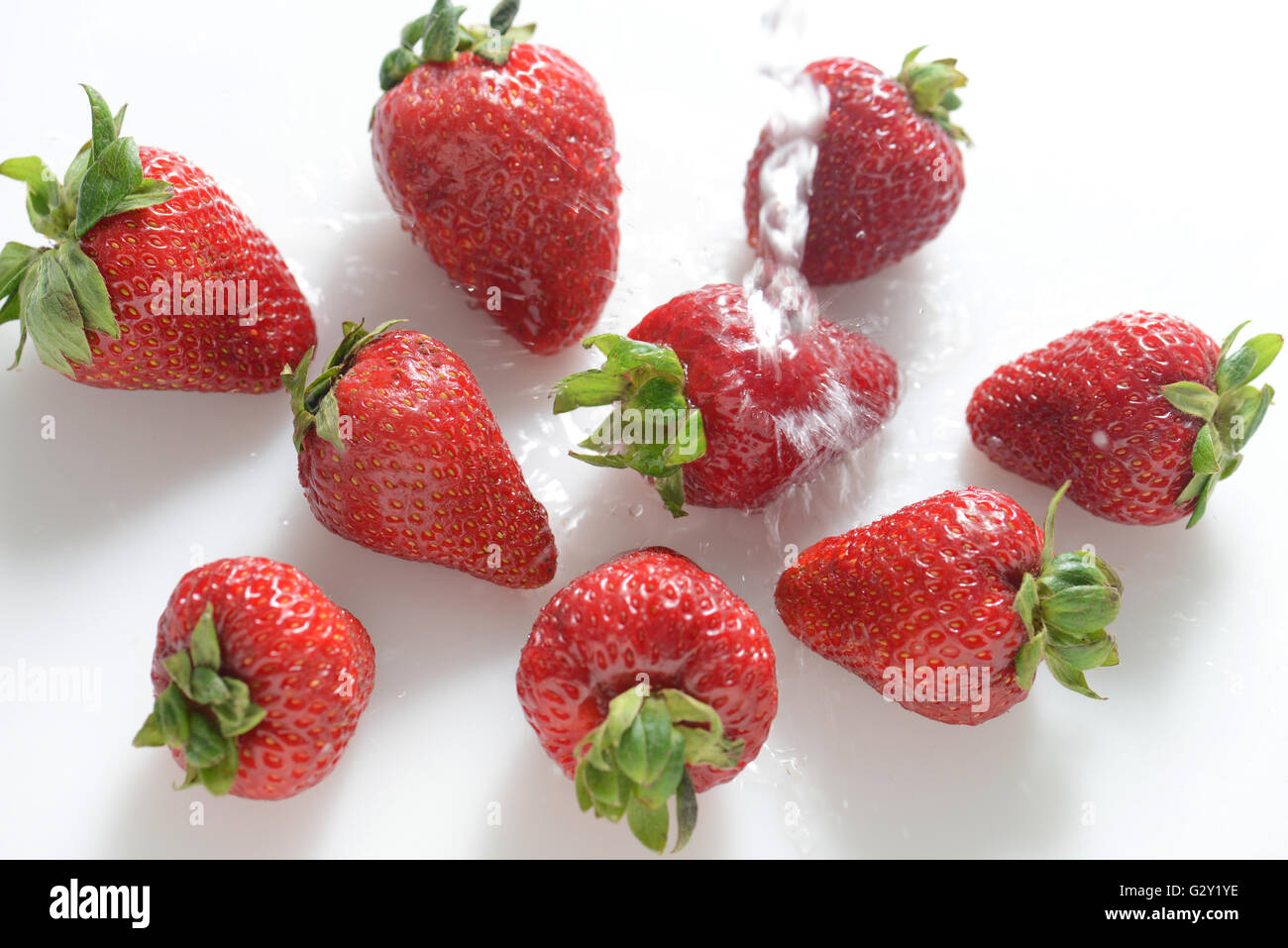 strawberry group being washed with water splash Stock Photo - Alamy