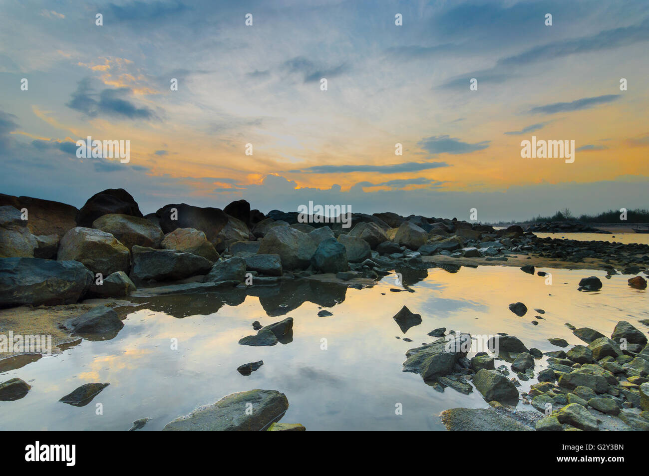 Beach rock with sunrise background Stock Photo - Alamy