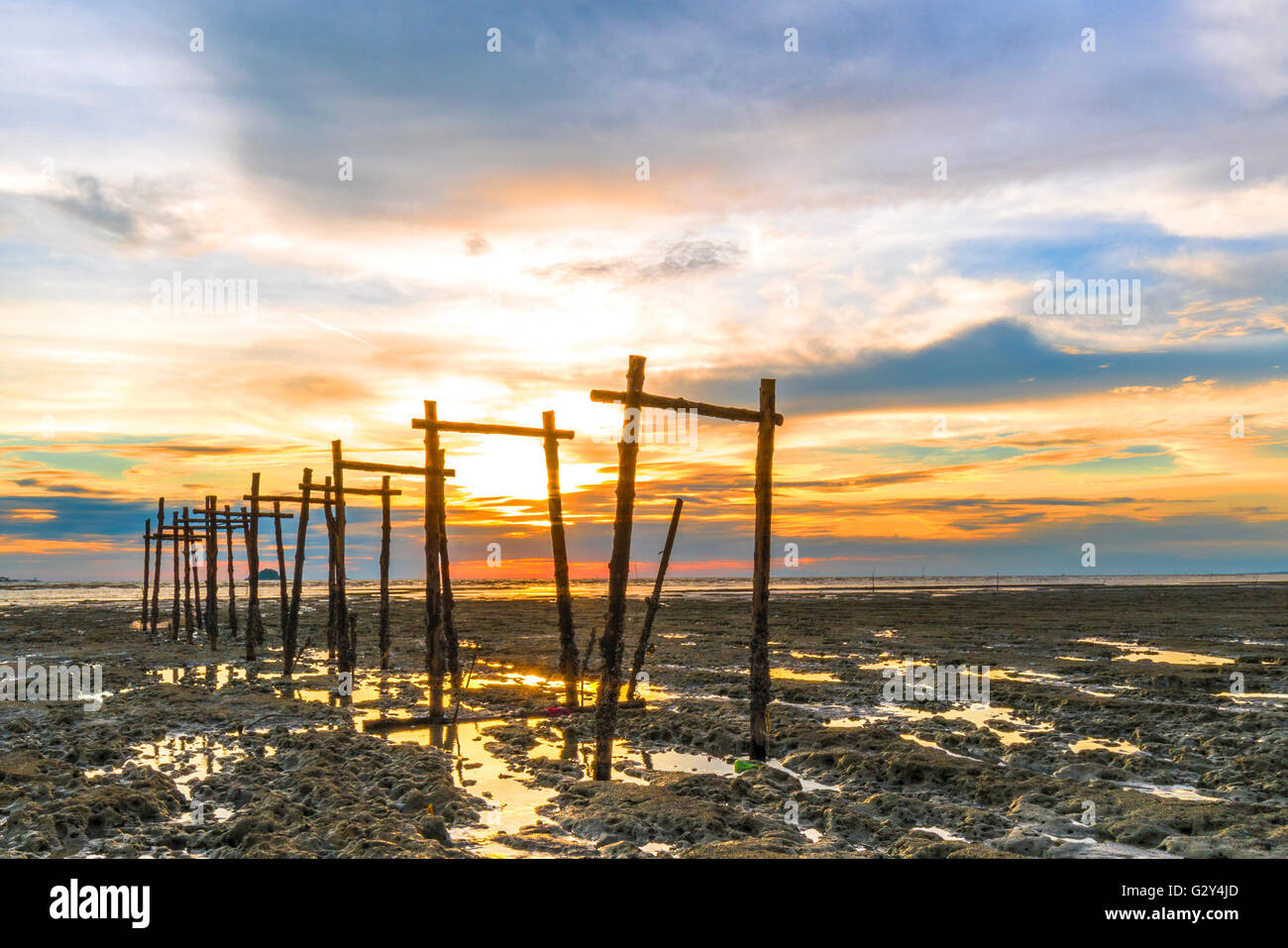 Wooden jetty with sunset background Stock Photo - Alamy