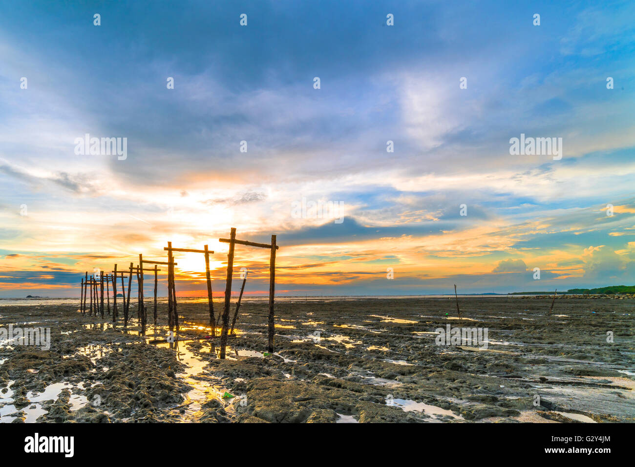 Wooden jetty with sunset background Stock Photo - Alamy