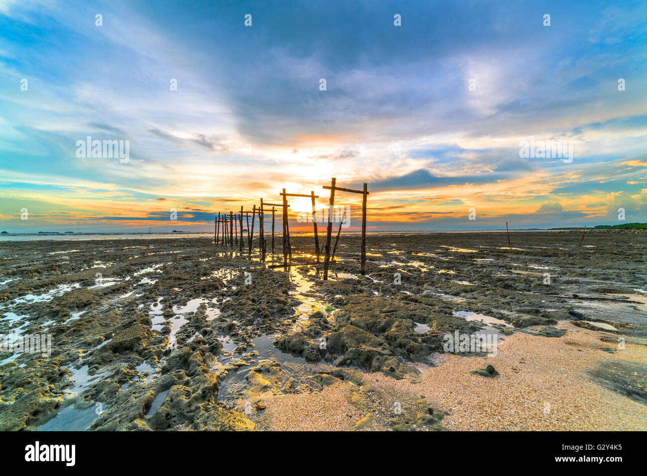 Wooden jetty with sunset background Stock Photo - Alamy