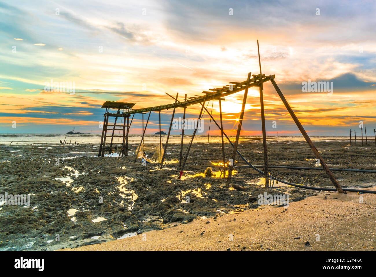 Wooden jetty with sunset background Stock Photo - Alamy