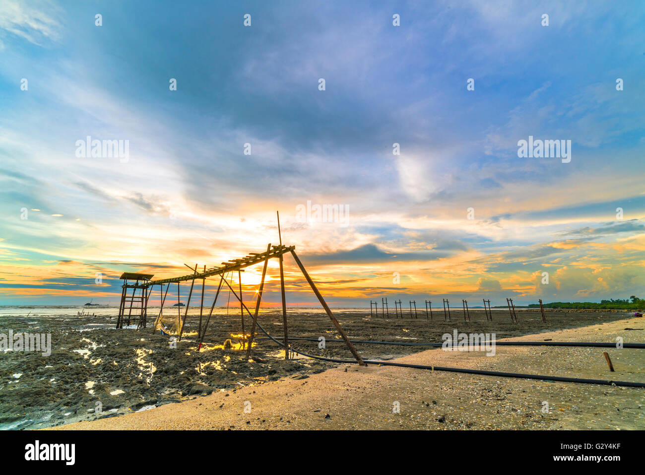 Wooden jetty with sunset background Stock Photo - Alamy