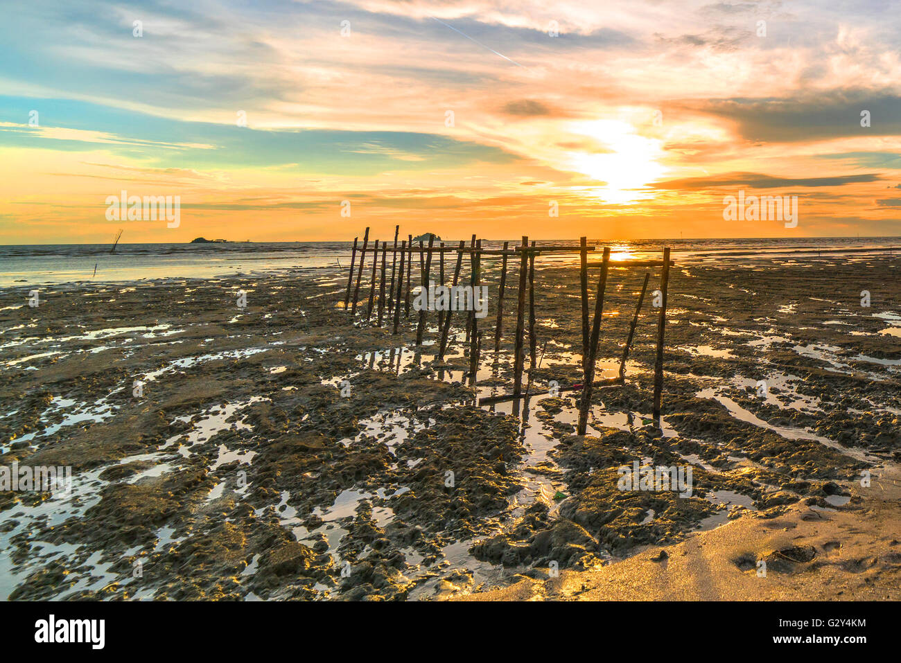 Wooden jetty with sunset background Stock Photo - Alamy
