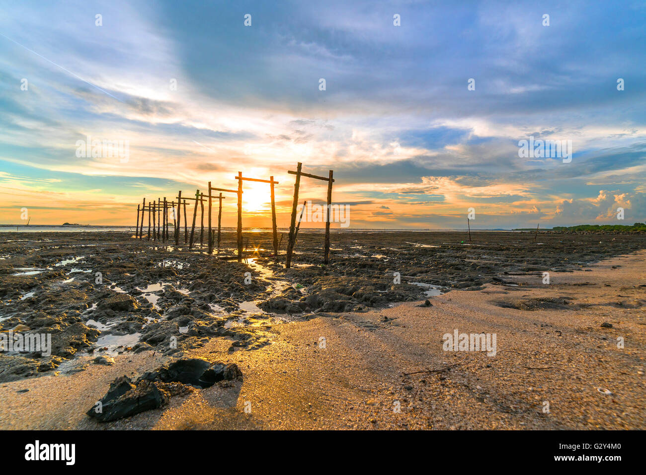 Wooden jetty with sunset background Stock Photo - Alamy