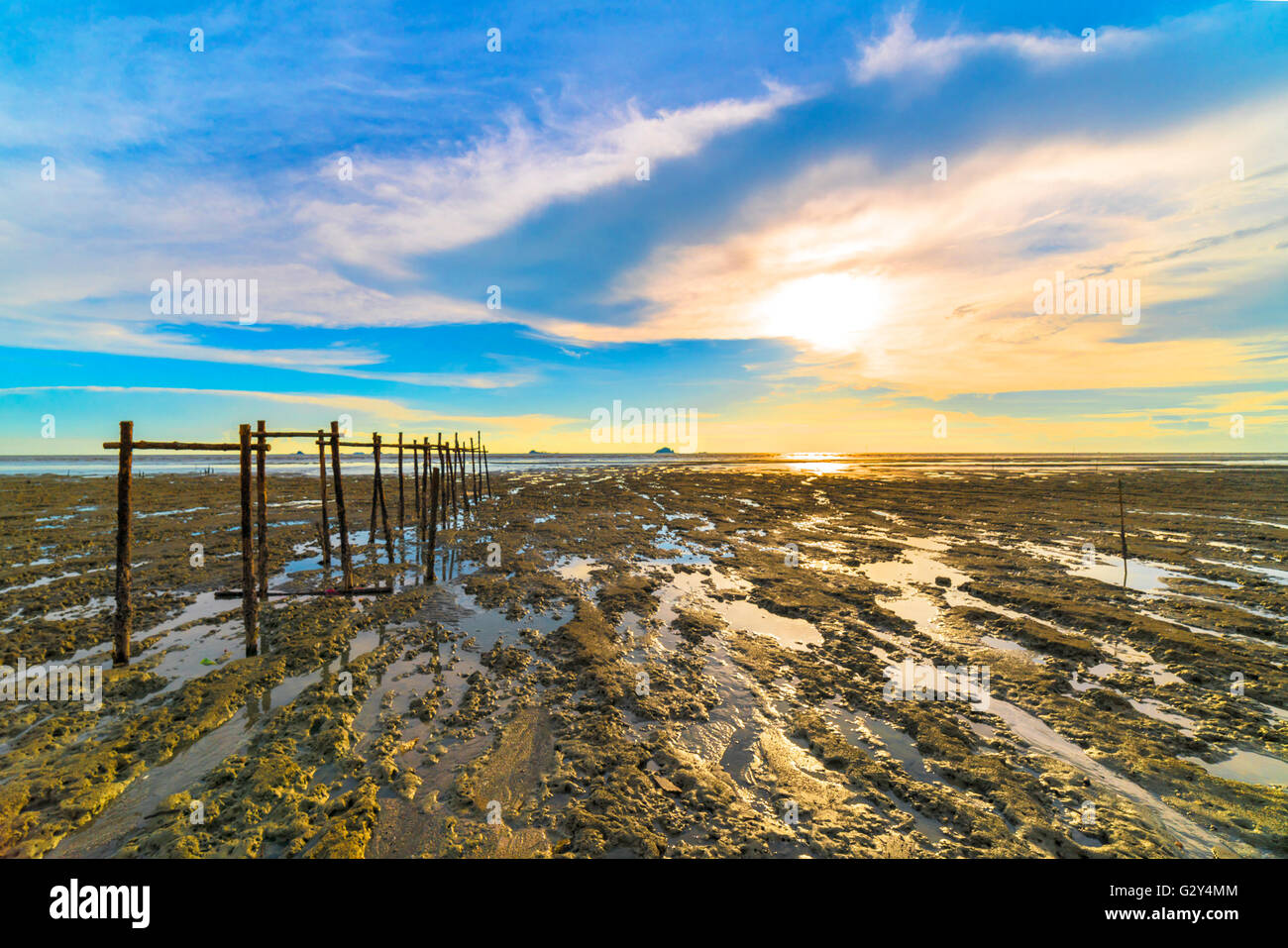 Wooden jetty with sunset background Stock Photo - Alamy