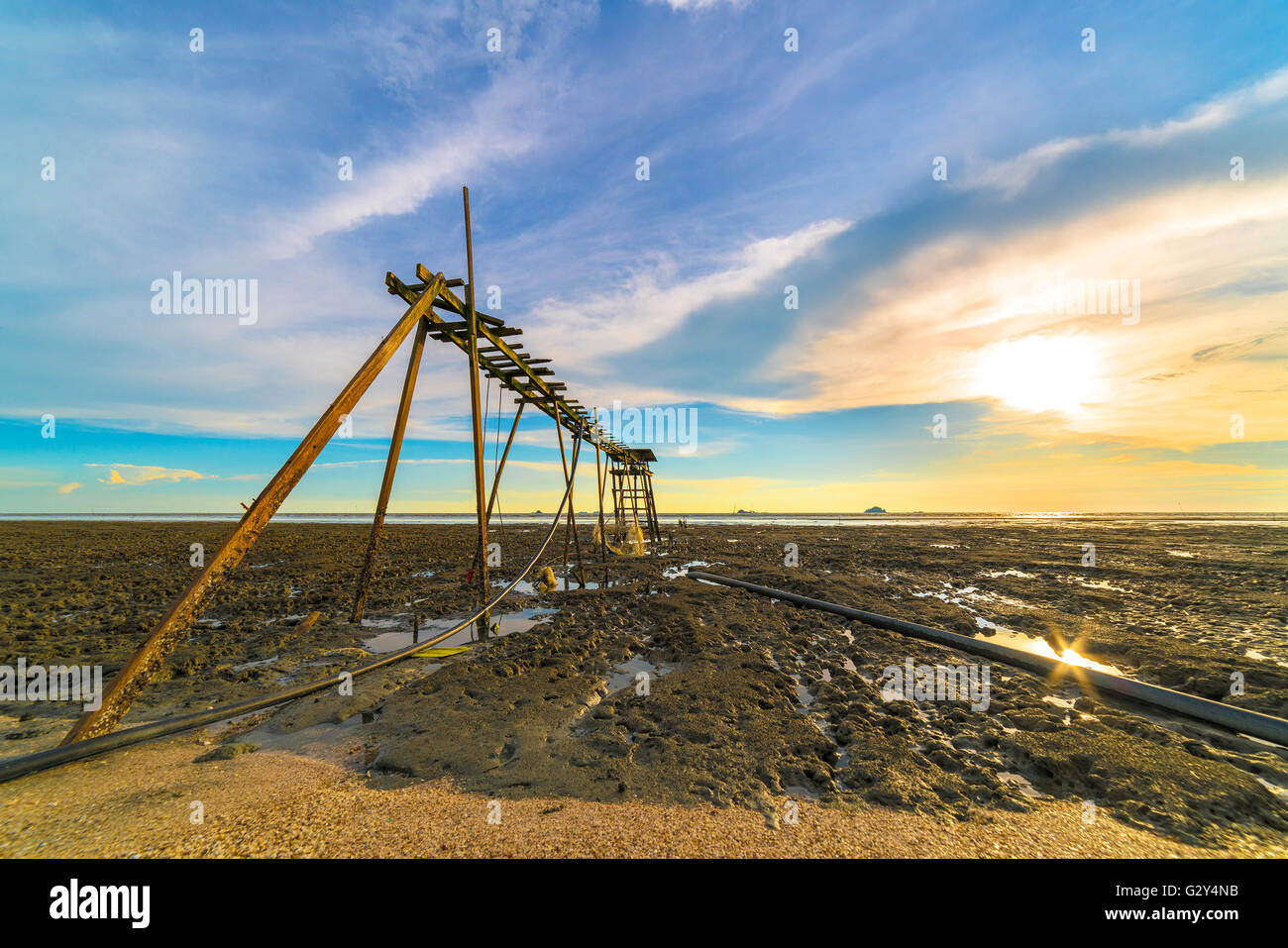 Wooden jetty with sunset background Stock Photo - Alamy