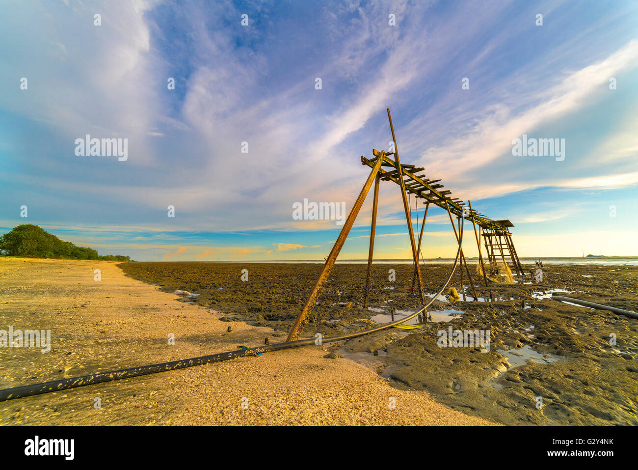 Wooden jetty with sunset background Stock Photo - Alamy