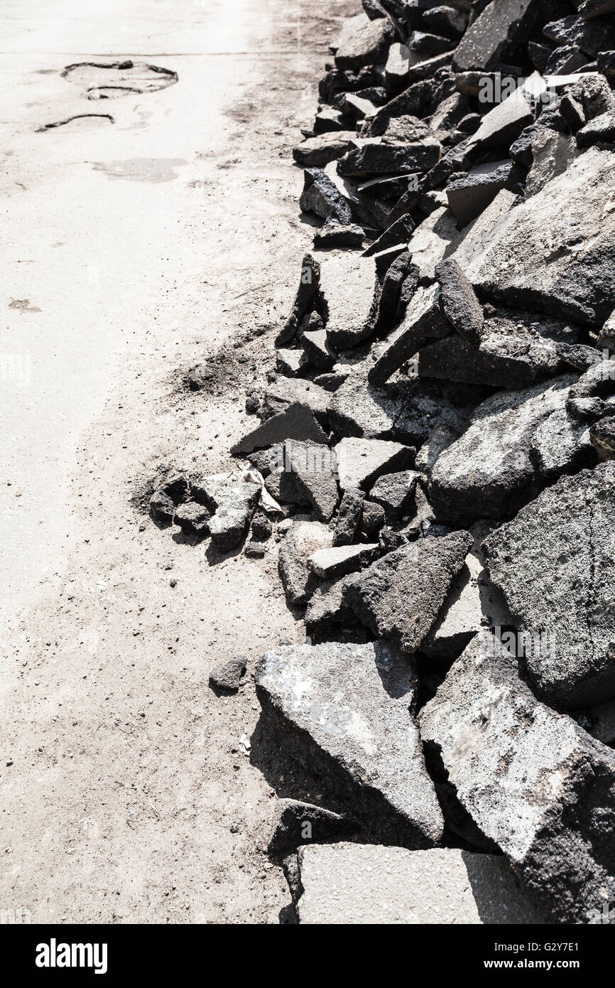repair of road - pile of asphalt pieces removed from the road on the ...