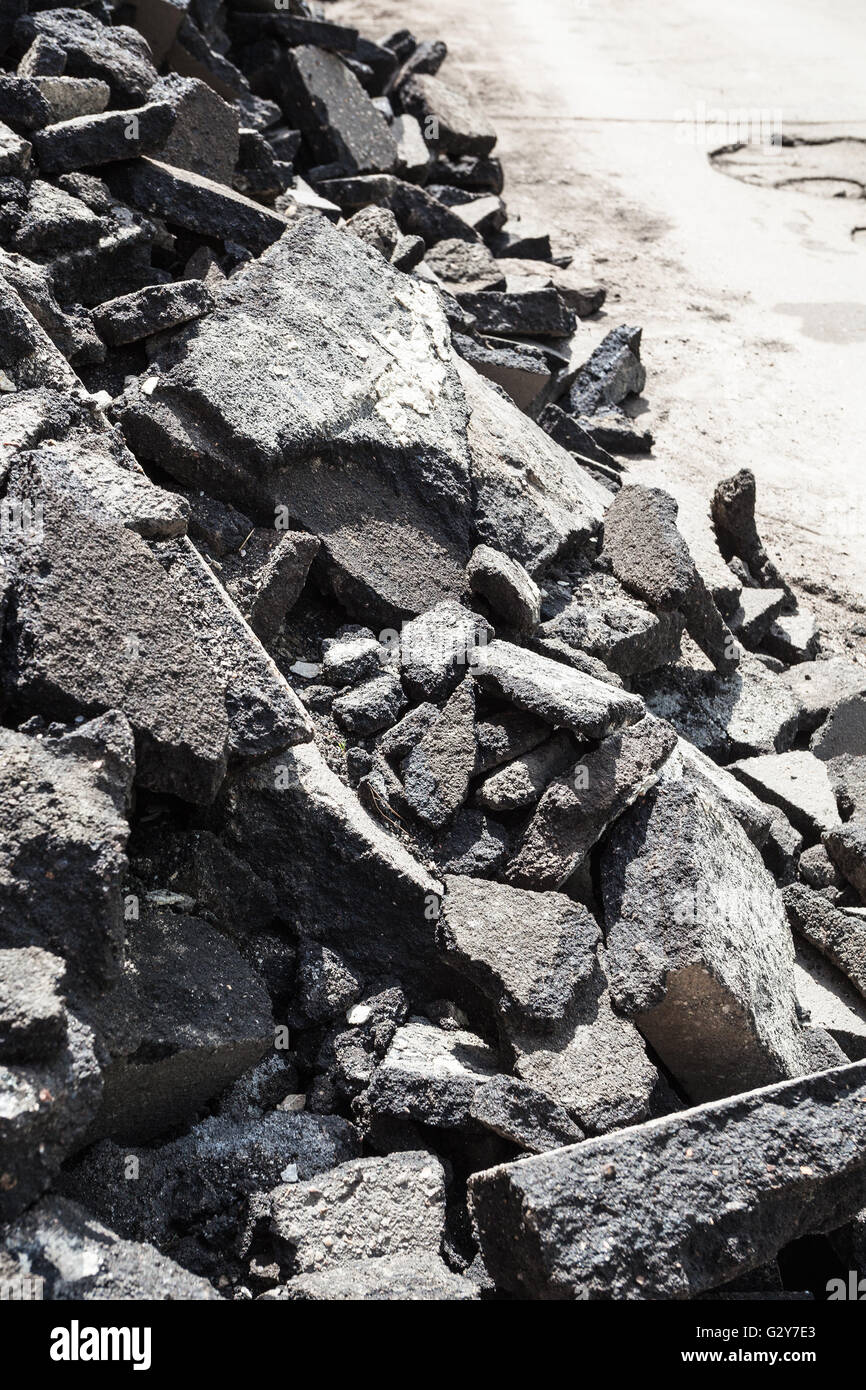 repair of road - many old asphalt pieces close up removed from road ...
