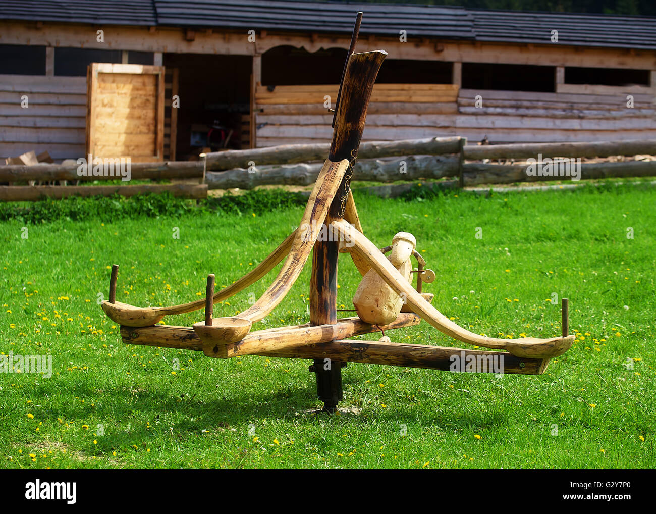 wooden carousel with wooden lamb, on the meadow Stock Photo - Alamy