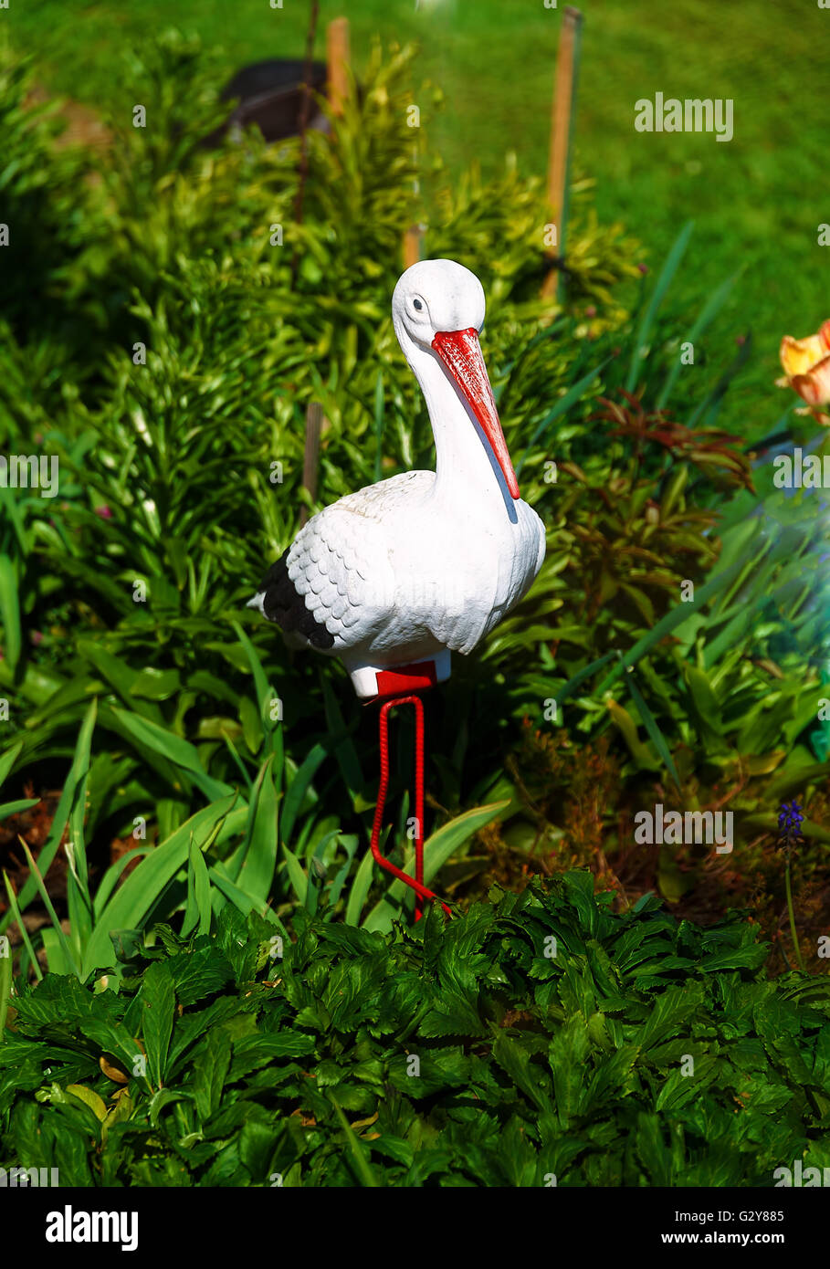 stork sculpture in garden with green plants Stock Photo - Alamy