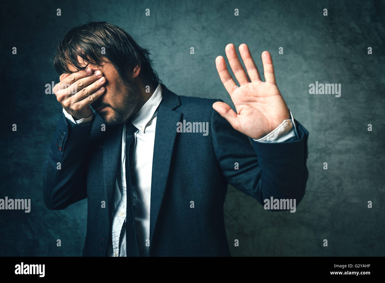 Crooked politician hiding face from newspaper photographers after ...