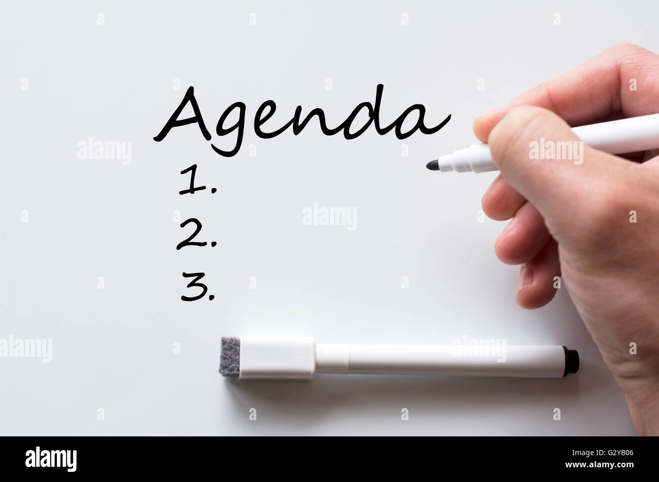Human hand writing agenda on whiteboard Stock Photo - Alamy