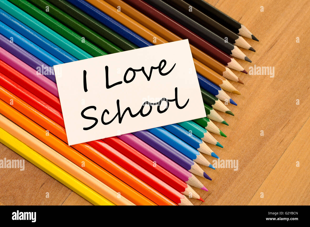 I love school text concept and colored pencil on wooden background ...
