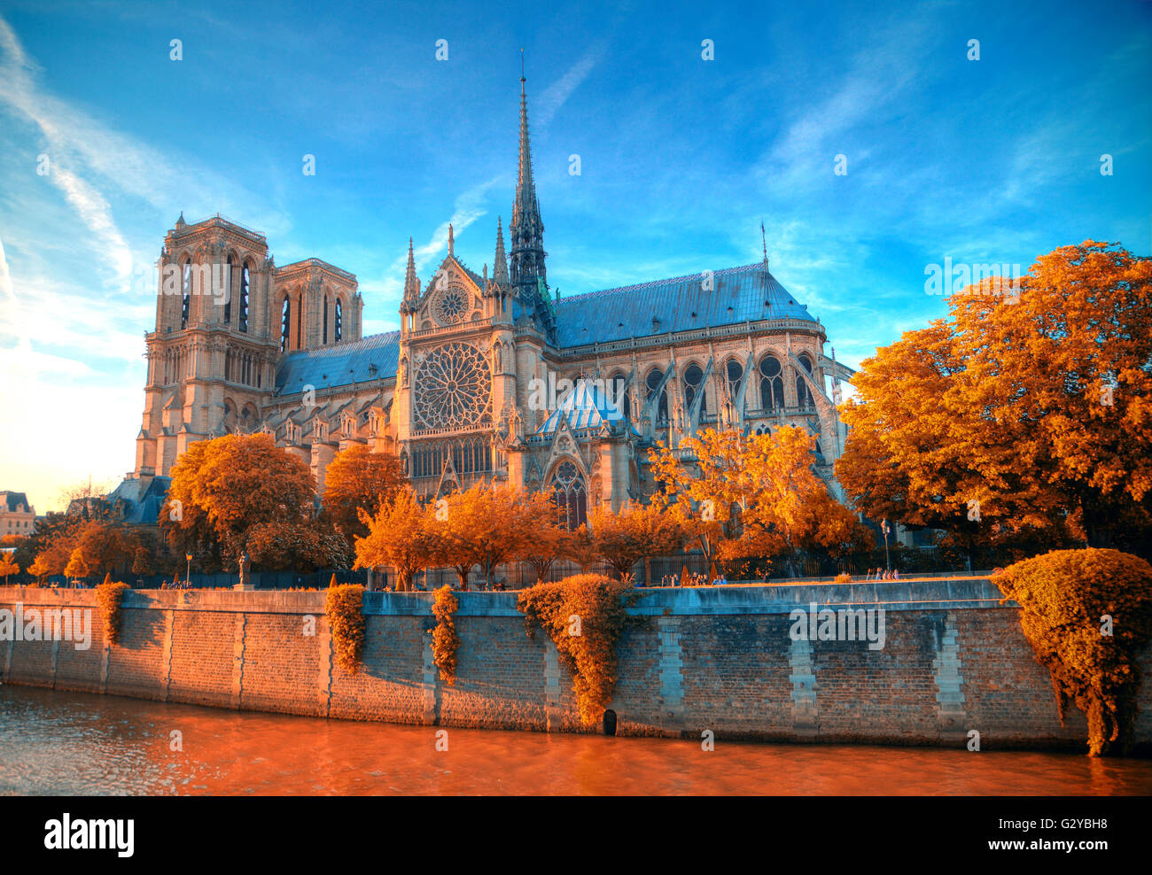 Gorgeous sunset over Notre Dame cathedral with puffy clouds, Paris ...