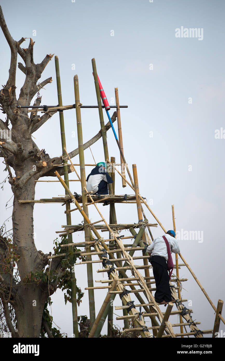 Preparing a bamboo rocket for the flying contest during Pa'O people ...