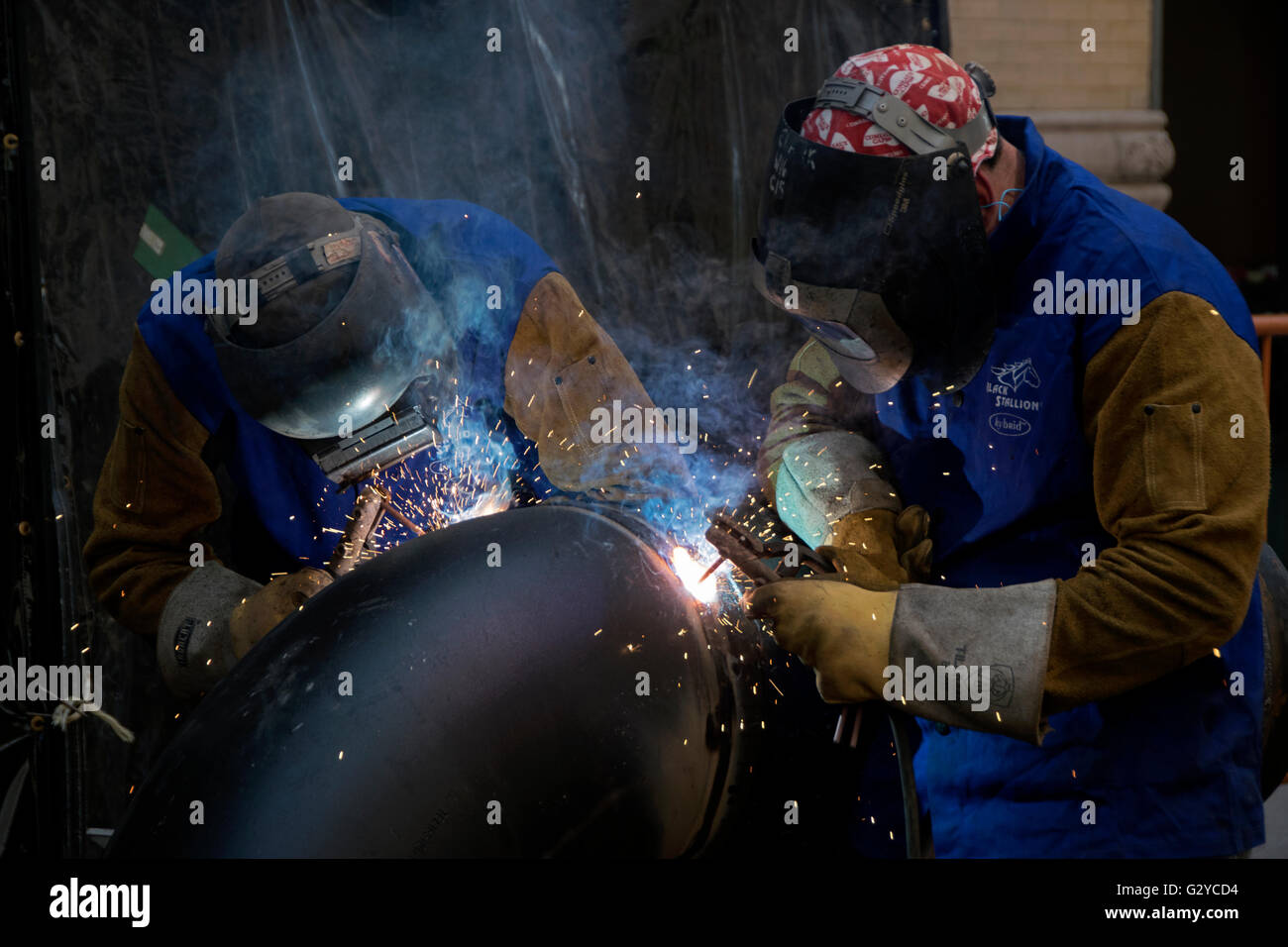 Two Con Ed welders welding a gas pipe in Greenwich Village, New York ...