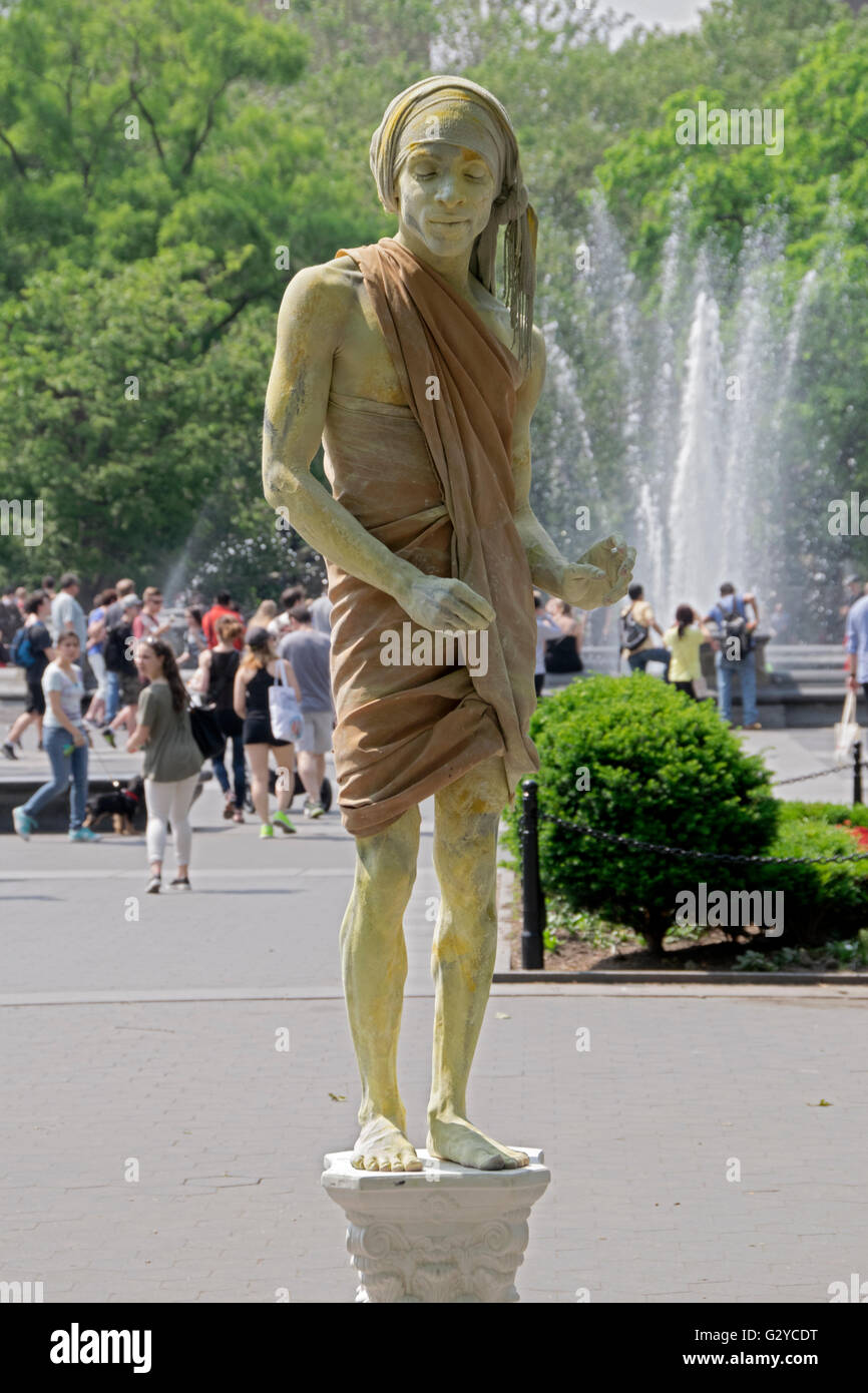 A mime busker who stays still to collect donations in Washington Square ...