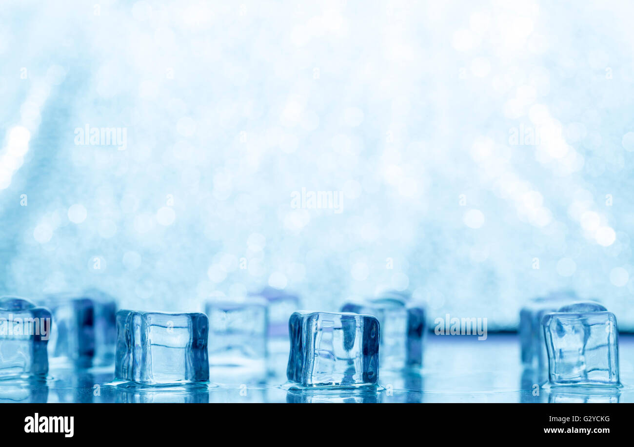 Many blue melting ice cubes on glass Stock Photo - Alamy