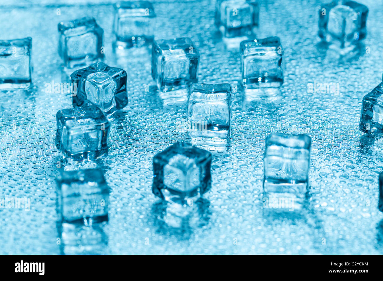 Many blue melting ice cubes on glass Stock Photo - Alamy