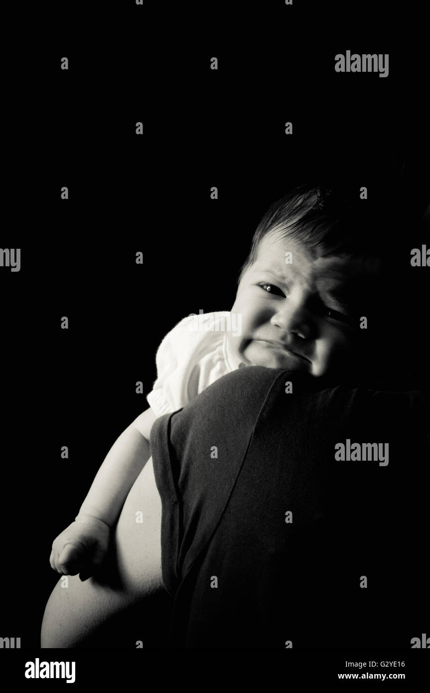 Upset newborn baby on its mothers shoulder Stock Photo - Alamy