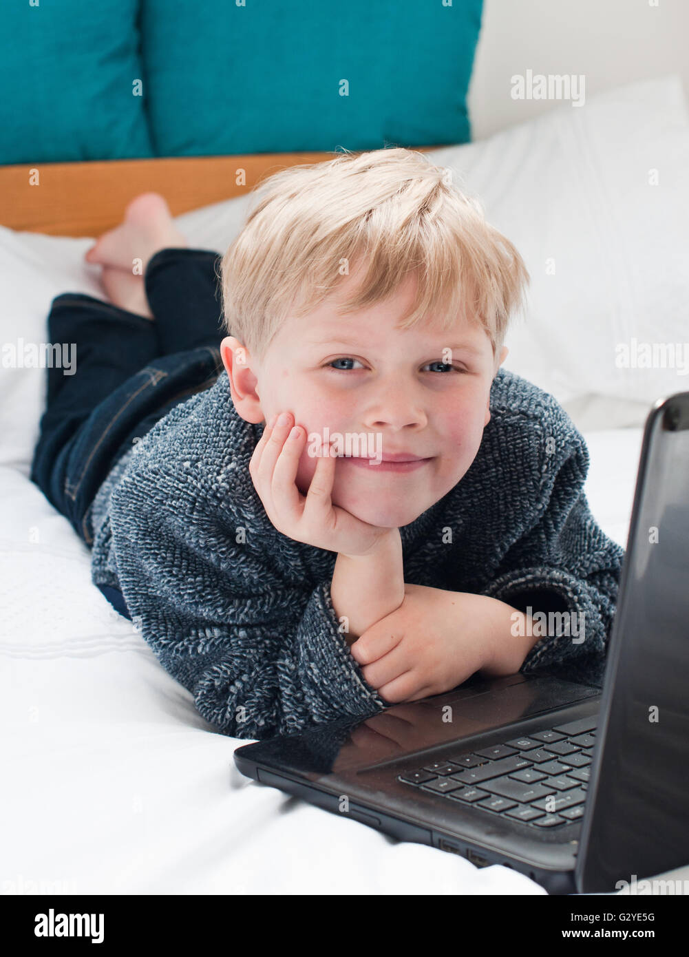 Happy boy with computer Stock Photo - Alamy