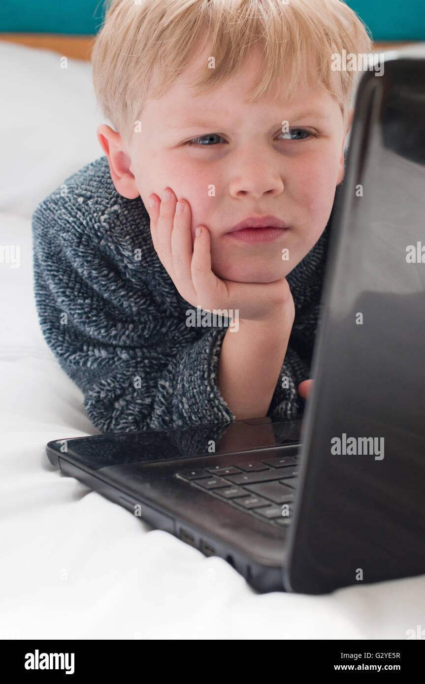Confused boy using social media online Stock Photo - Alamy