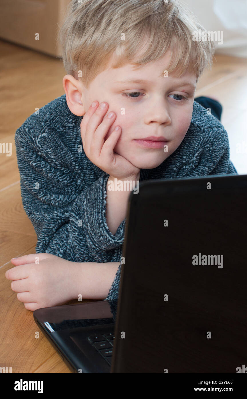 cute boy looking at the world wide web Stock Photo - Alamy